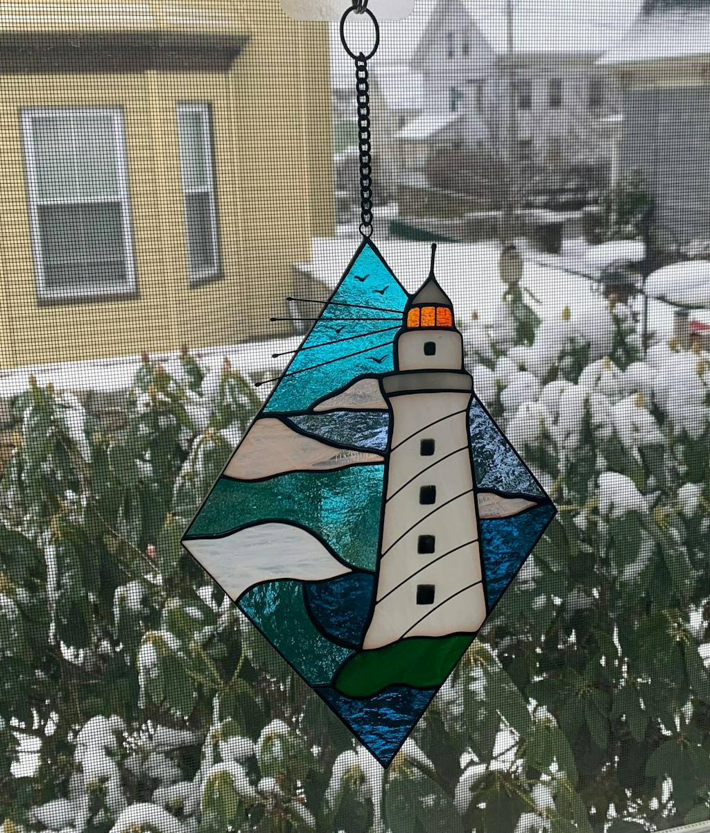 Stained glass lighthouse in the waters window panel – Glass Art Stories