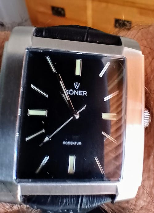 Rio, a rectangular watch in polished steel with red dial